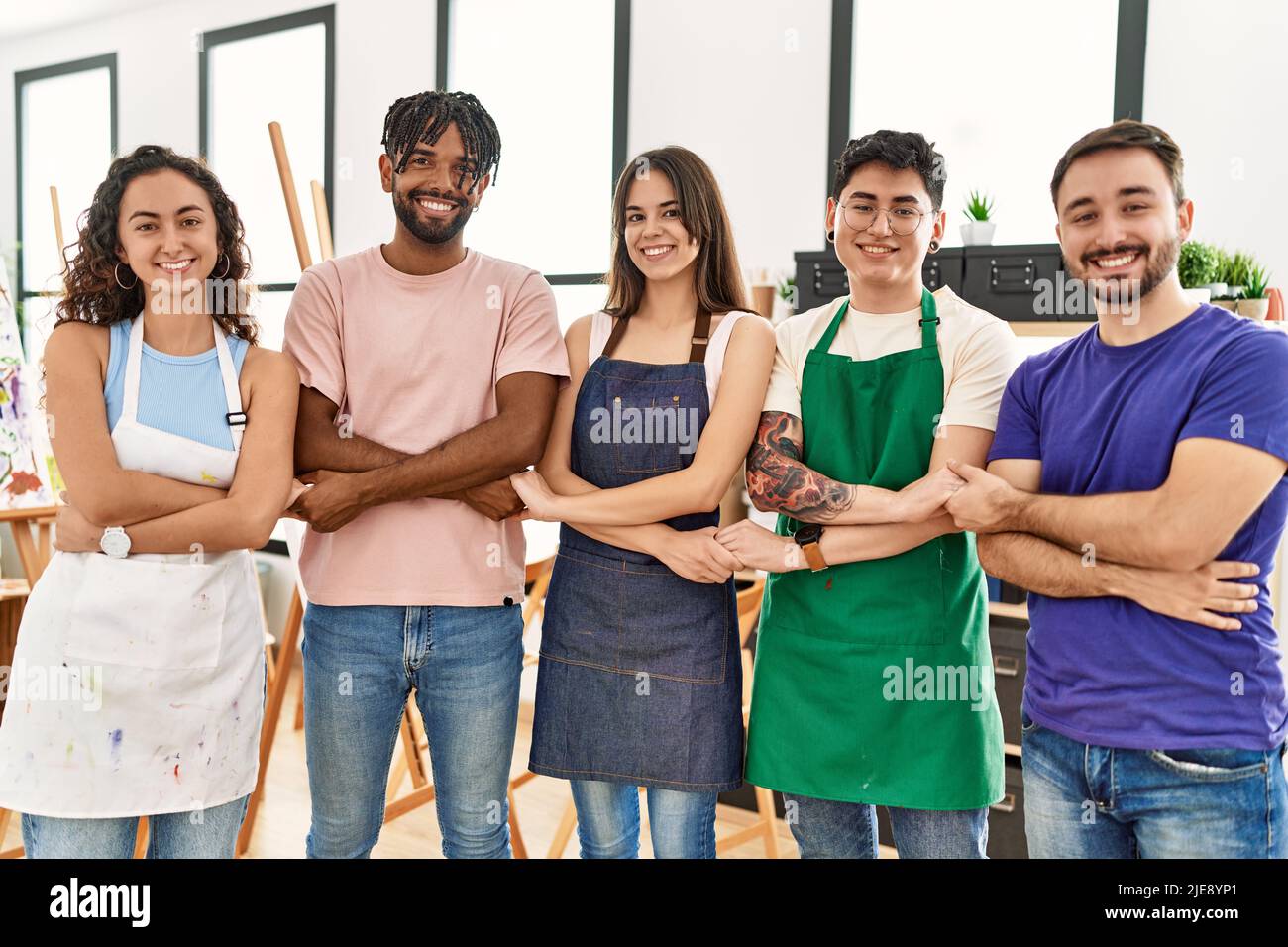 Group of young draw students smiling happy standing with arms crossed ...