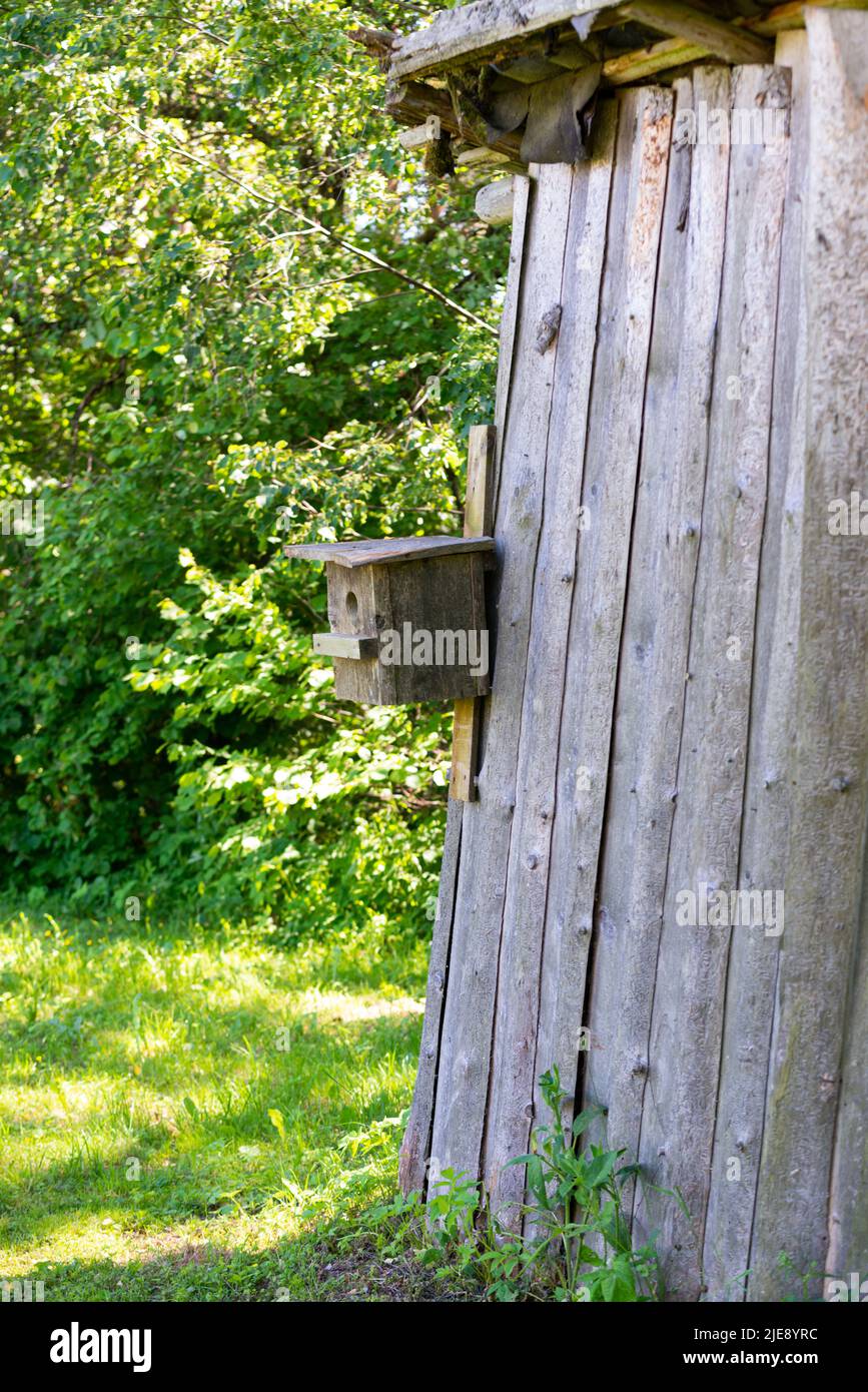 wooden barn with a wooden bird cage attached to the wall Stock Photo ...