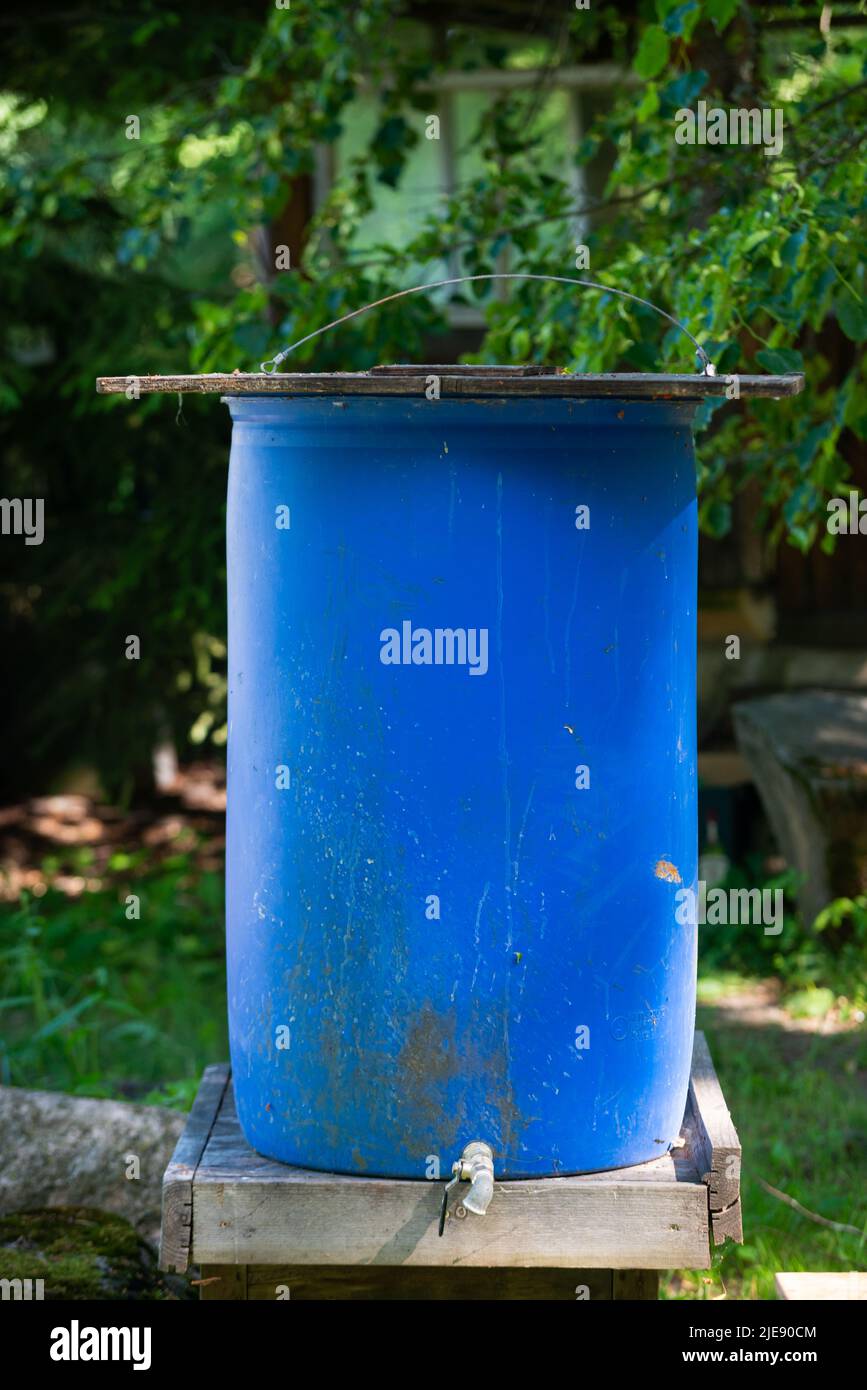 huge blue water barrel for washing hands at a rural tourism campsite ...