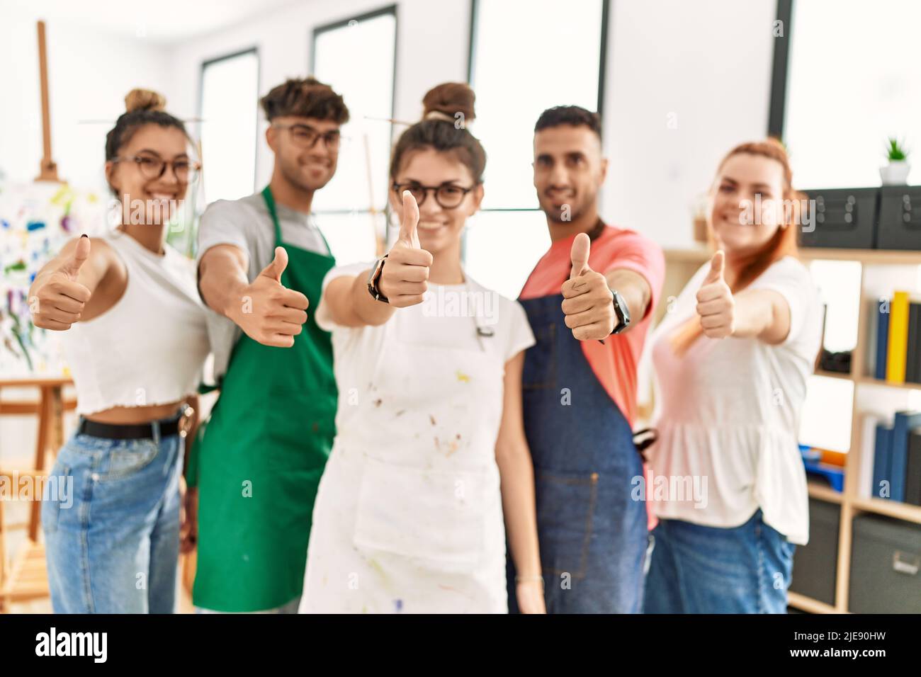 Group of young draw students smiling happy doing ok sign with thumbs up ...