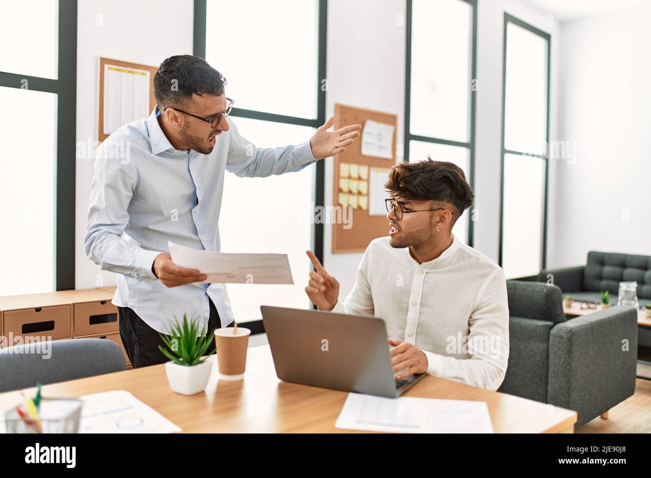 Two hispanic men business workers arguing at office Stock Photo - Alamy
