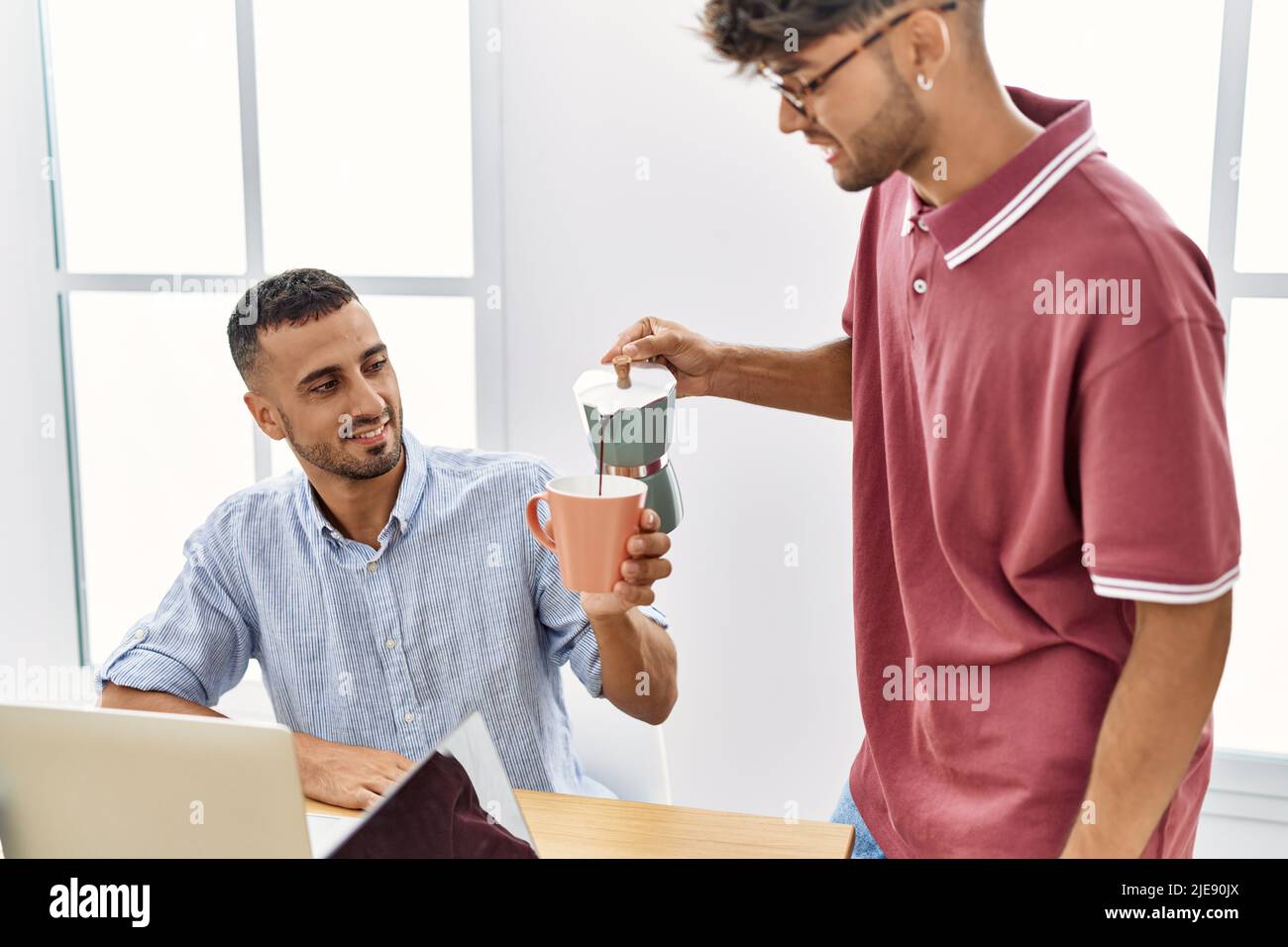Two business workers smiling happy drinking coffee at the office Stock ...