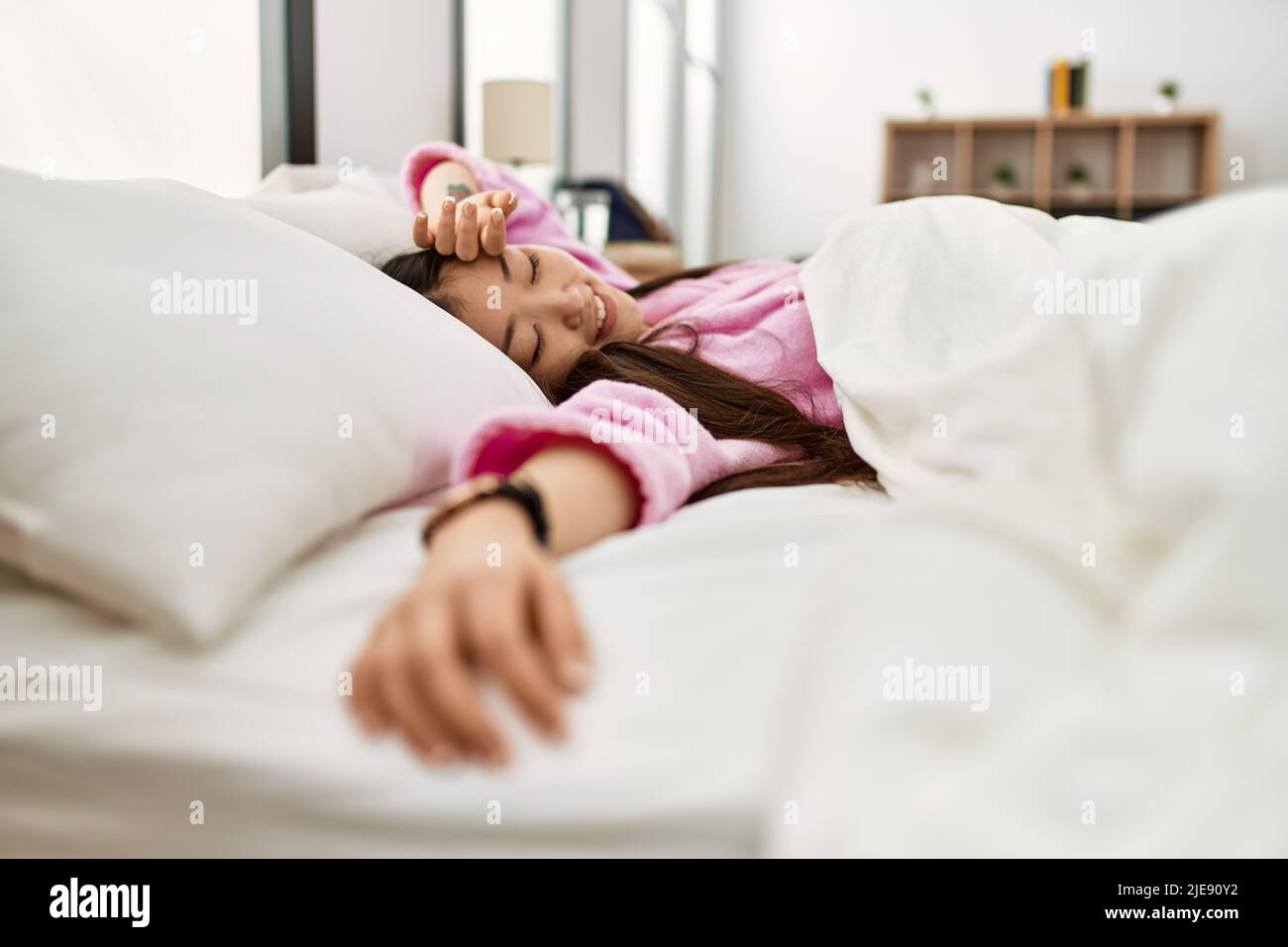 Young chinese girl sleeping on the bed at bedroom Stock Photo - Alamy