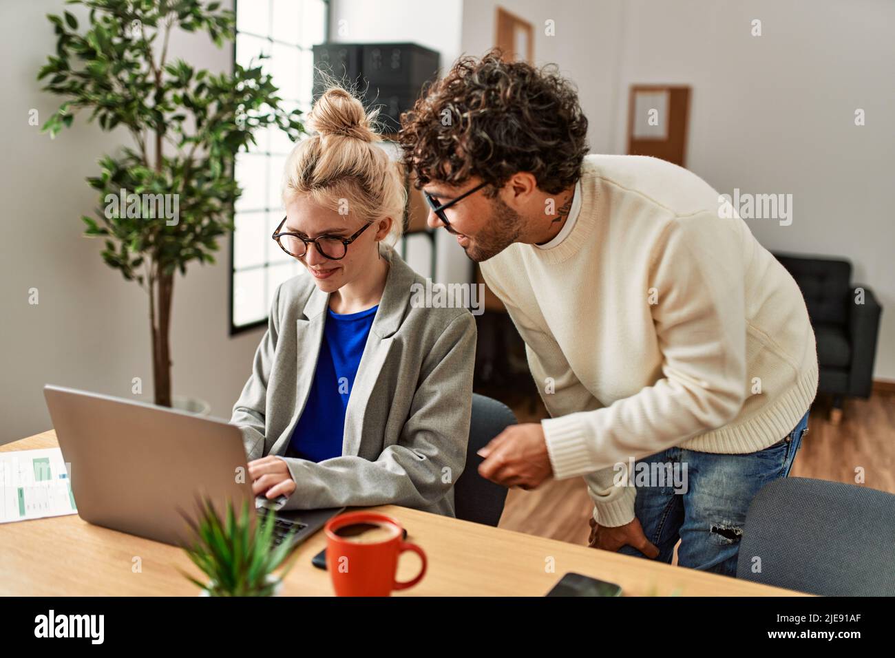 Two hispanic business workers smiling happy working at the office Stock Photo - Alamy