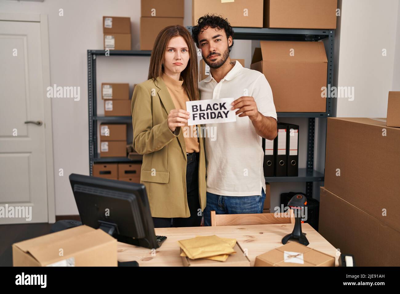 Young two people holding black friday banner at small business store ...