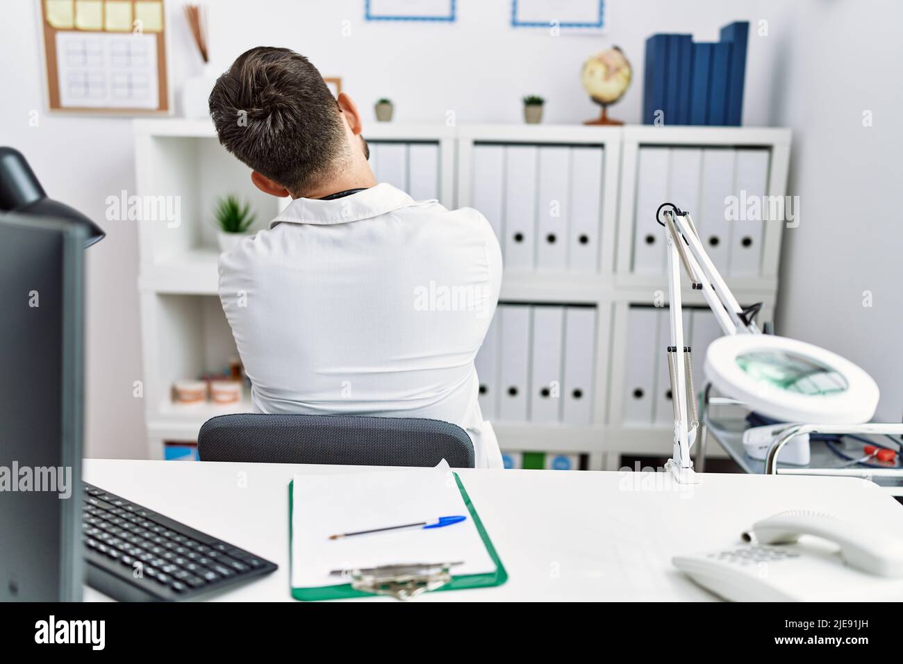 Young man with beard wearing doctor uniform and stethoscope at the ...