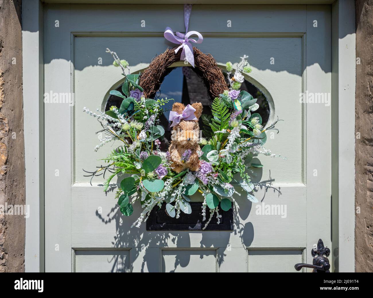 Charming garland with straw squirrel surrounded by grasses and flowers ...