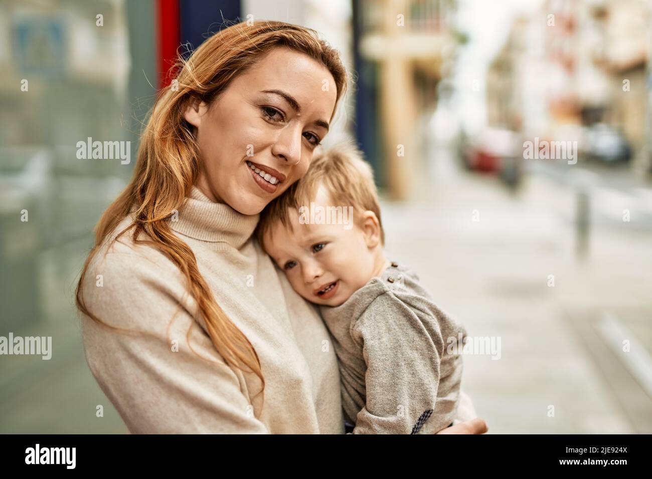 Beautiful family of mother and baby son hugging and bonding together ...