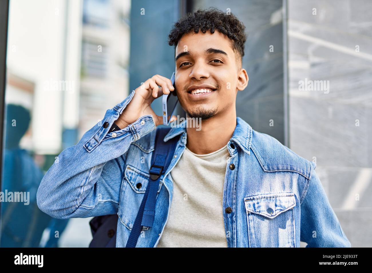 Hispanic young man speaking on the phone at the university Stock Photo ...