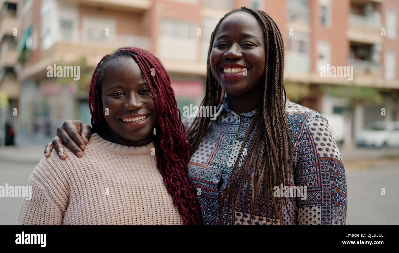Two african american friends smiling confident hugging each other ...