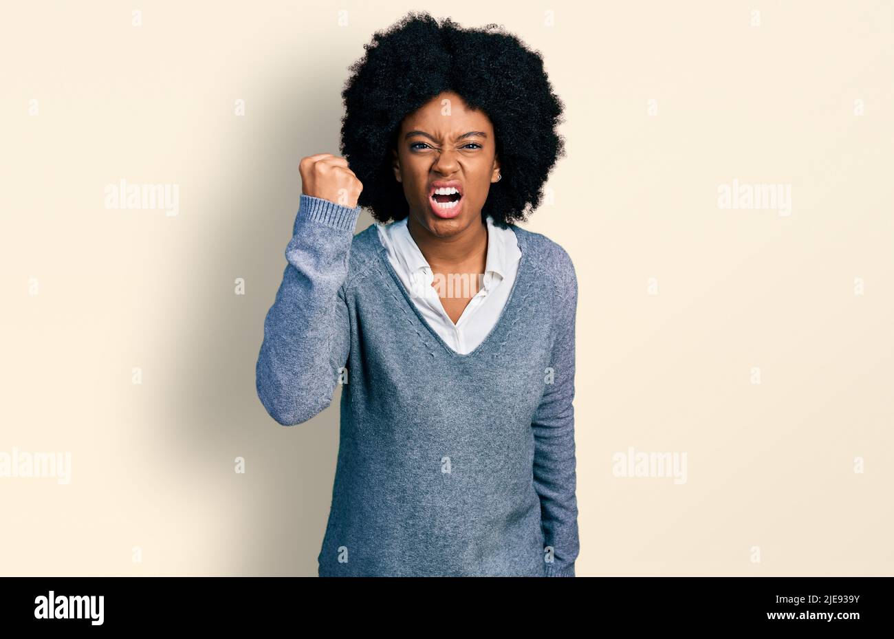 Young african american woman wearing business clothes angry and mad ...