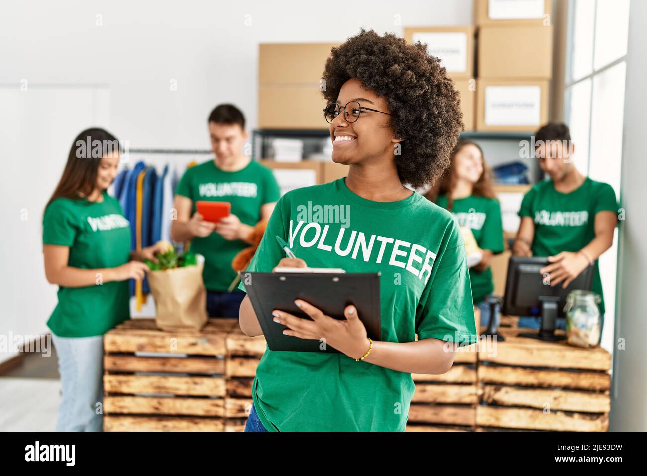 Group of young volunteers smiing happy working at charity center Stock ...