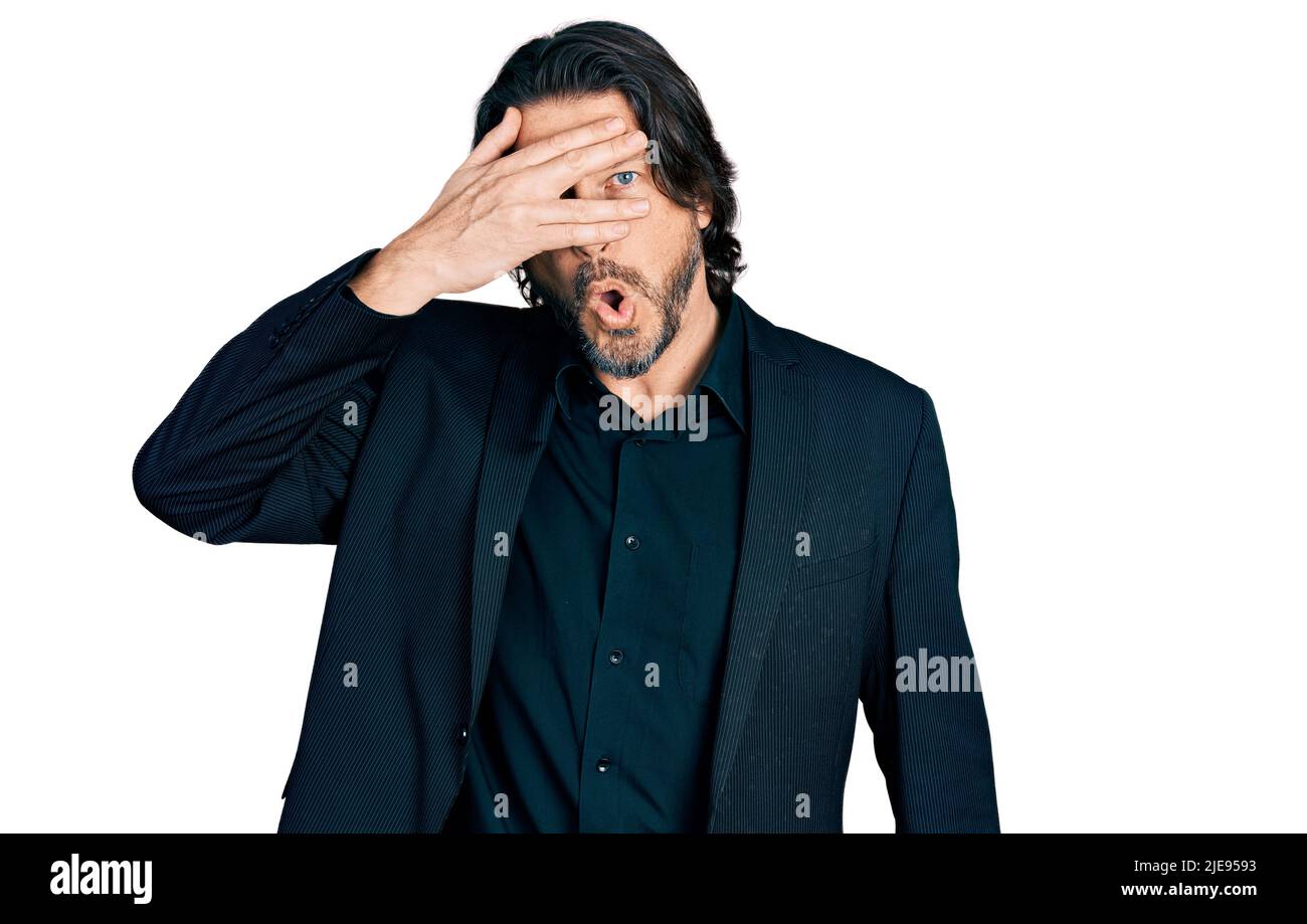 Middle age caucasian man wearing business clothes peeking in shock ...
