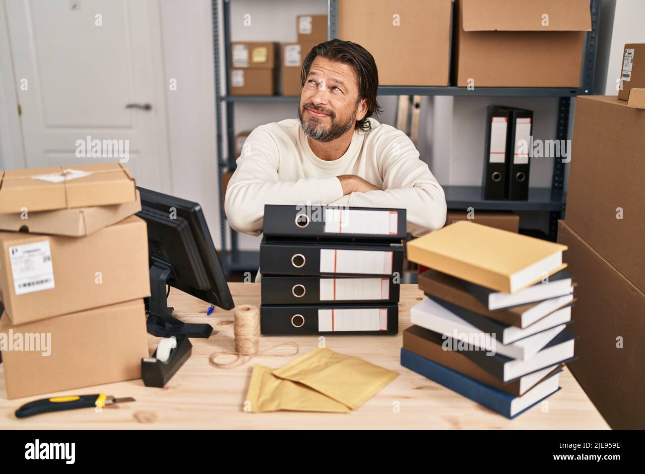 Handsome middle age man working at small business ecommerce smiling ...