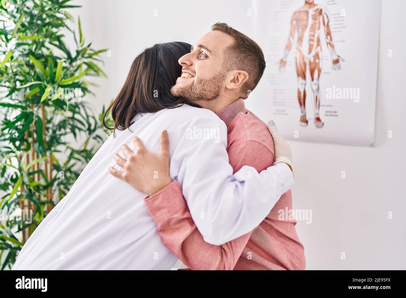 Man and woman doctor and patient hugging each other at clinic Stock ...