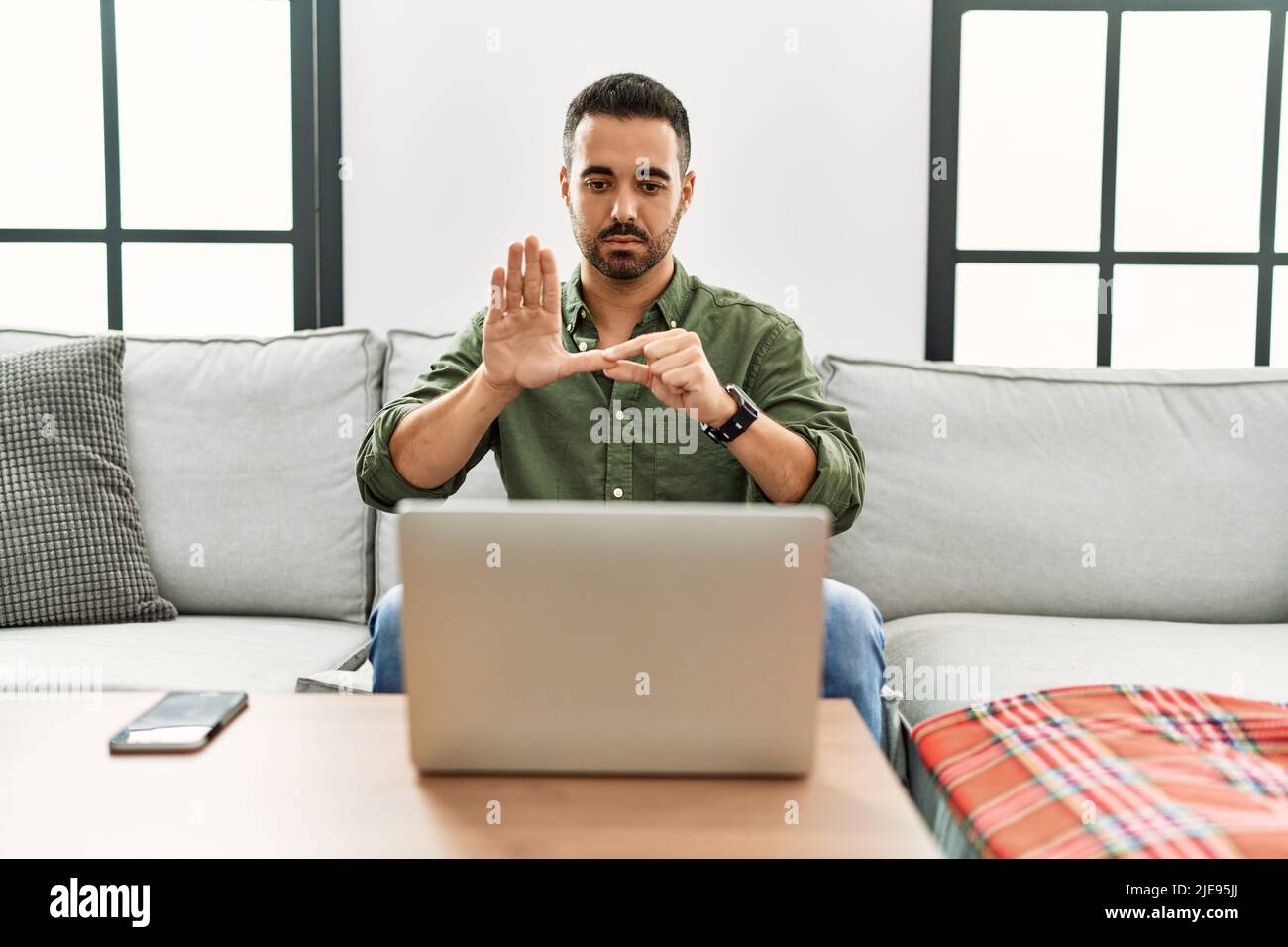 Young hispanic man having video call speaking with deaf language at ...