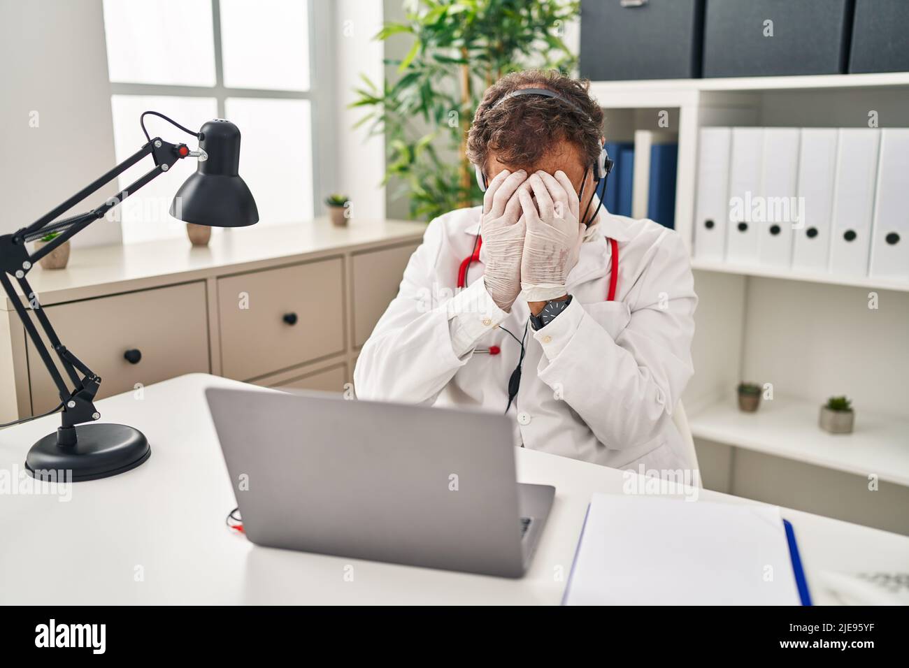 Senior doctor man working on online appointment with sad expression ...