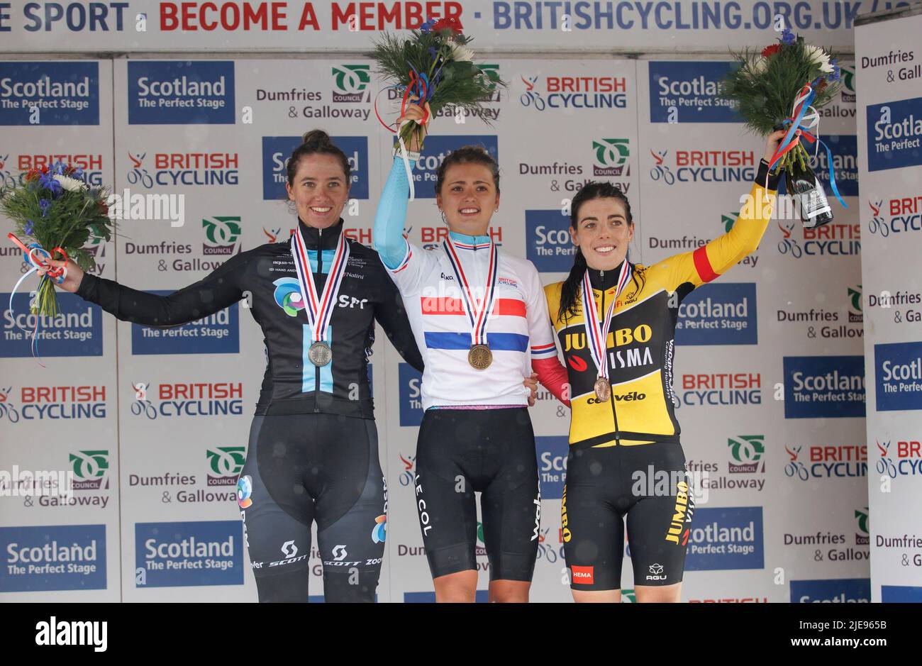 Alice Towers (centre) poses with her gold medal after winning the ...