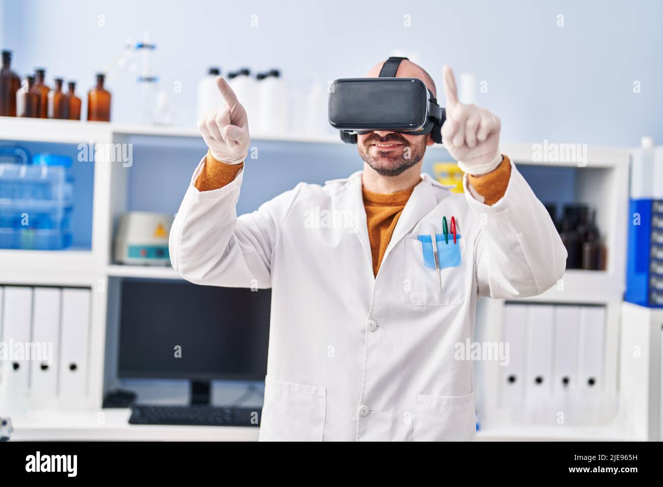 Young man scientist using virtual reality goggles at laboratory Stock ...