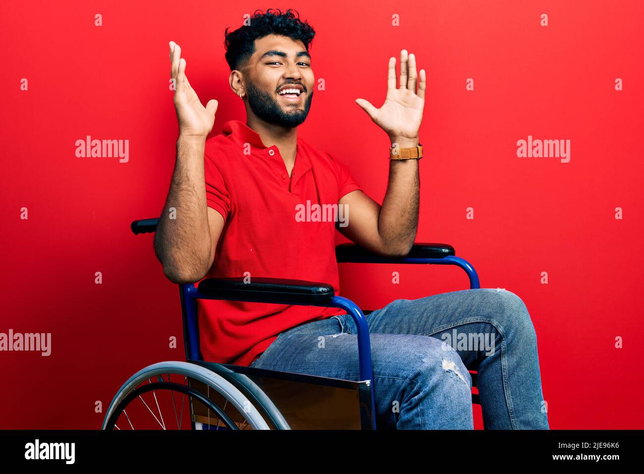 Arab man with beard sitting on wheelchair celebrating crazy and amazed ...