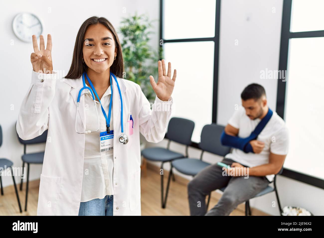 Young asian doctor woman at waiting room with a man with a broken arm ...