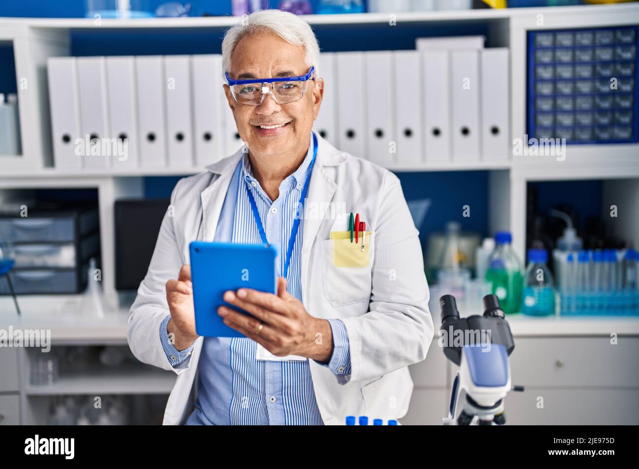 Senior man scientist using touchpad working at laboratory Stock Photo - Alamy