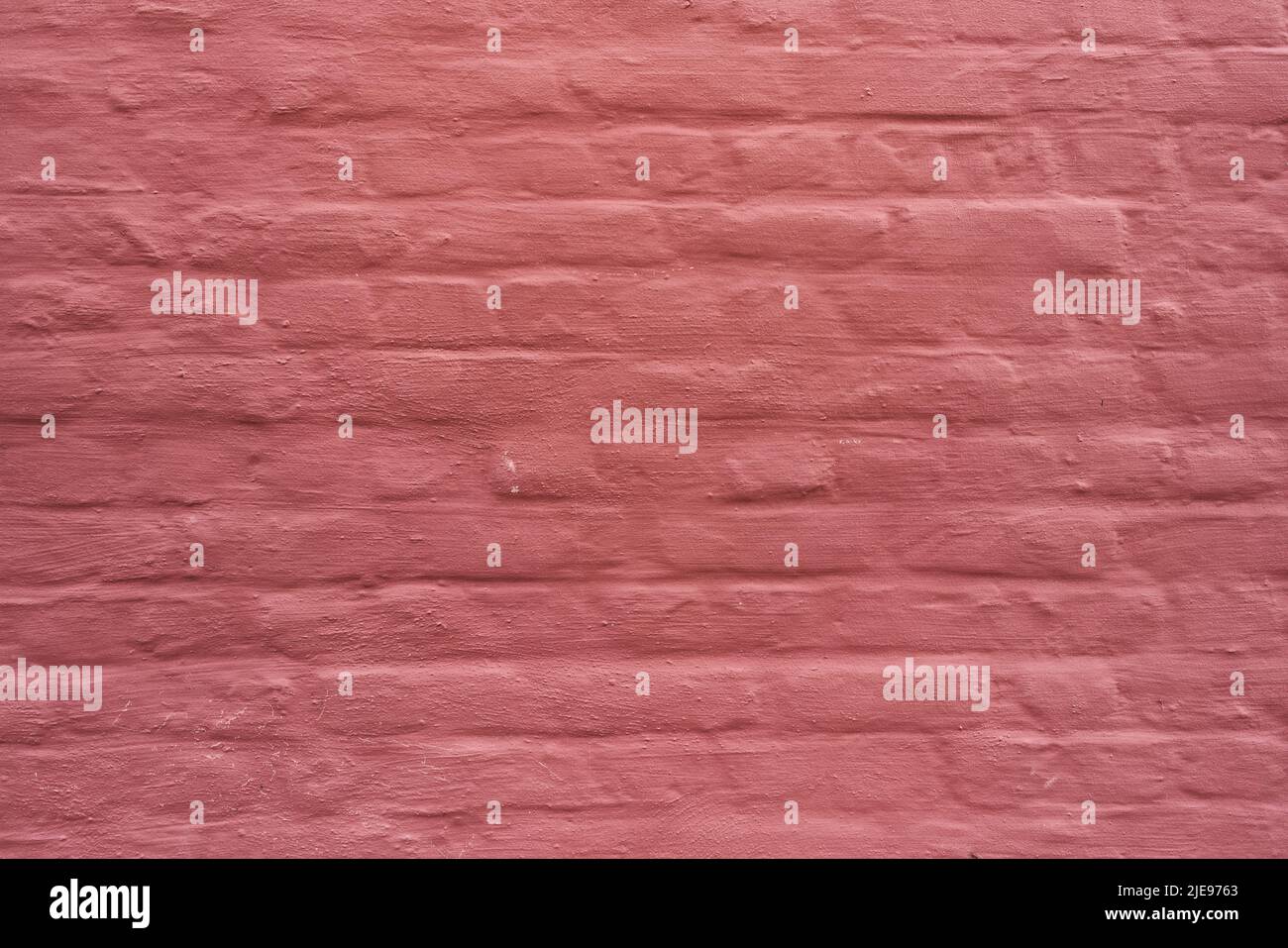 Painted red brick wall surface background Stock Photo - Alamy