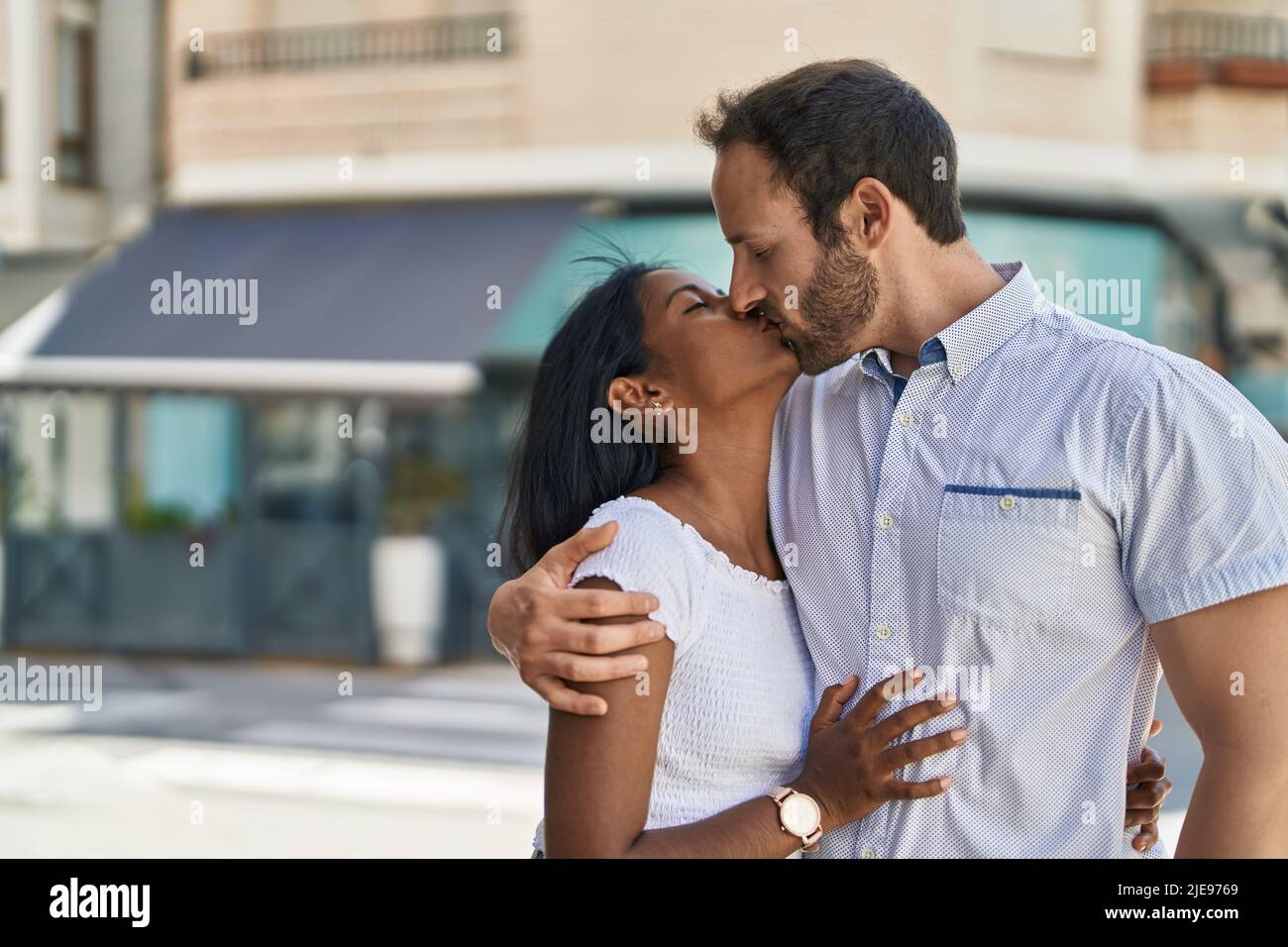 Man And Woman Interracial Couple Hugging Each Other And Kissing At