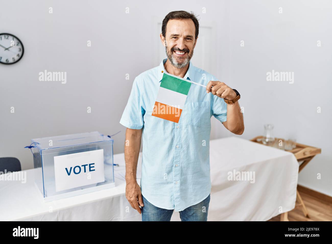 Middle age man with beard at political campaign election holding ...