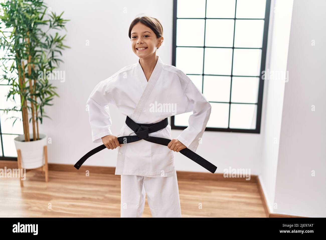 Young hispanic girl doing martial arts at training studio Stock Photo - Alamy