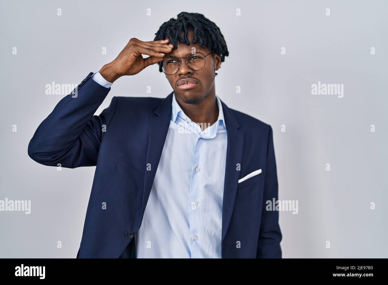 Young african man with dreadlocks wearing business jacket over white ...