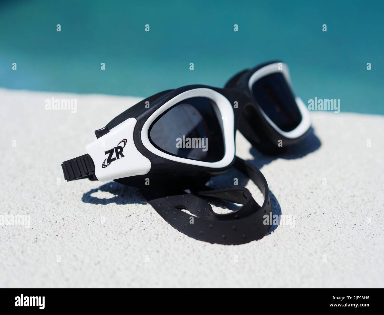 Closeup of a pair of black and white diving goggles by the side of a ...