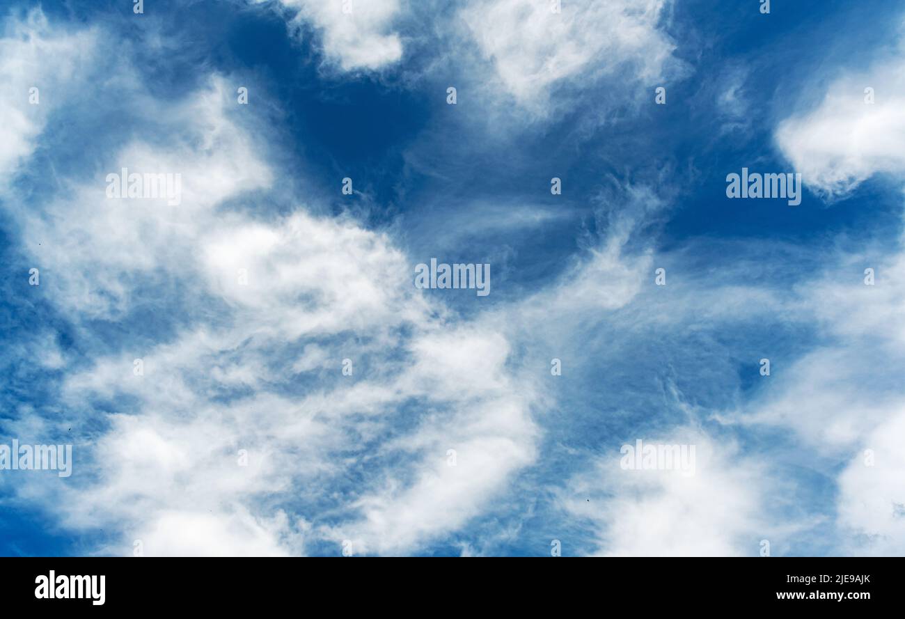 Sun against blue sky and white cumulus clouds hi-res stock photography and images - Alamy