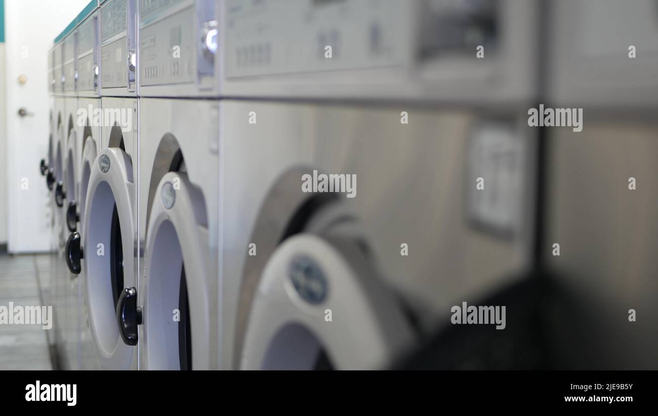 Row of washing and drying machines, public coin laundry in California ...