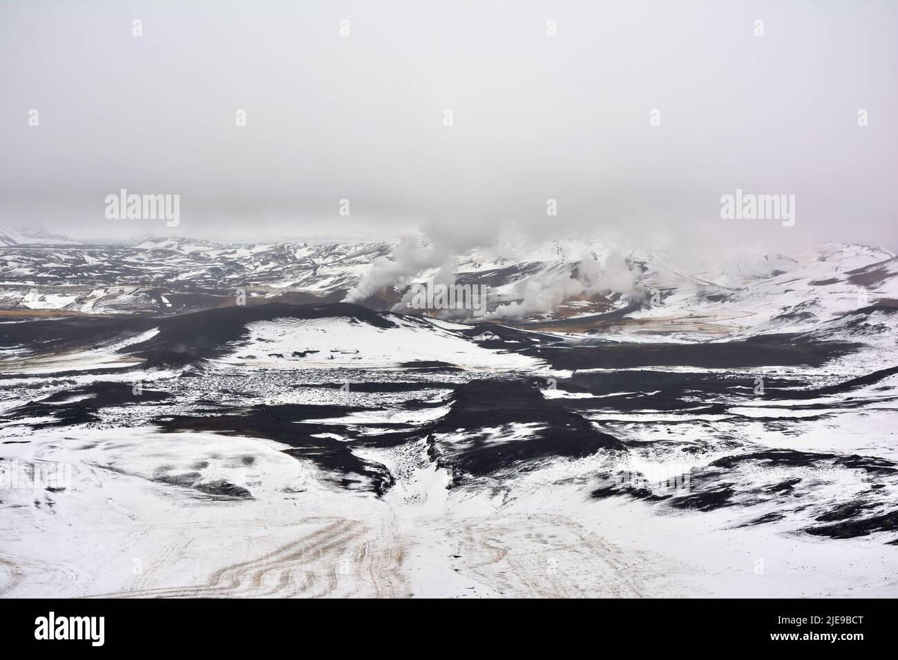 View from the top of Hverfjall volcano crater in winter. Snow and ...