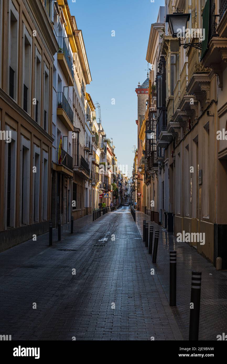 A photo looking down a side street in Seville, Spain Stock Photo - Alamy