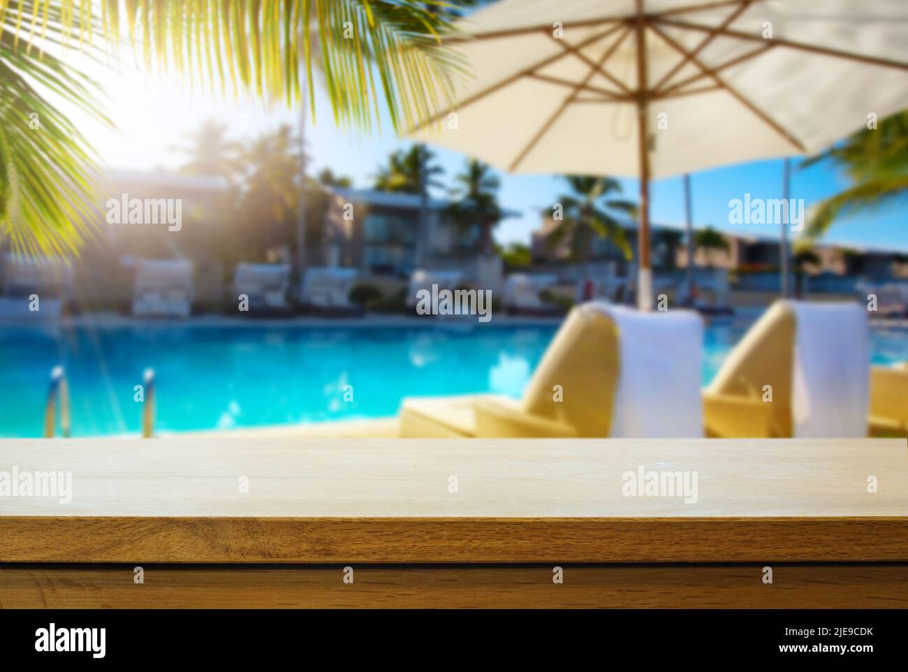Empty wooden table on sunny blurred tropical pool background. Outdoor ...