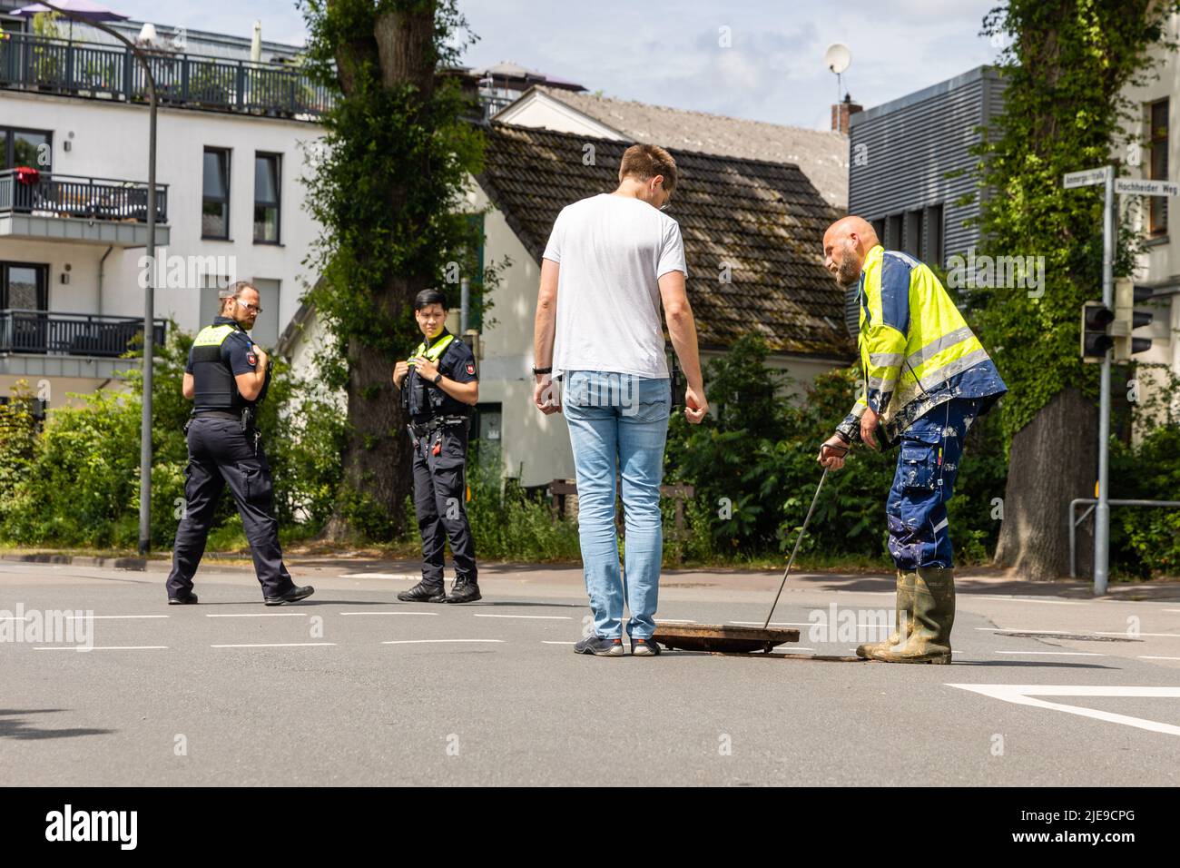 Oldenburg, Germany. 26th June, 2022. Marc Meyerholz opens a manhole ...
