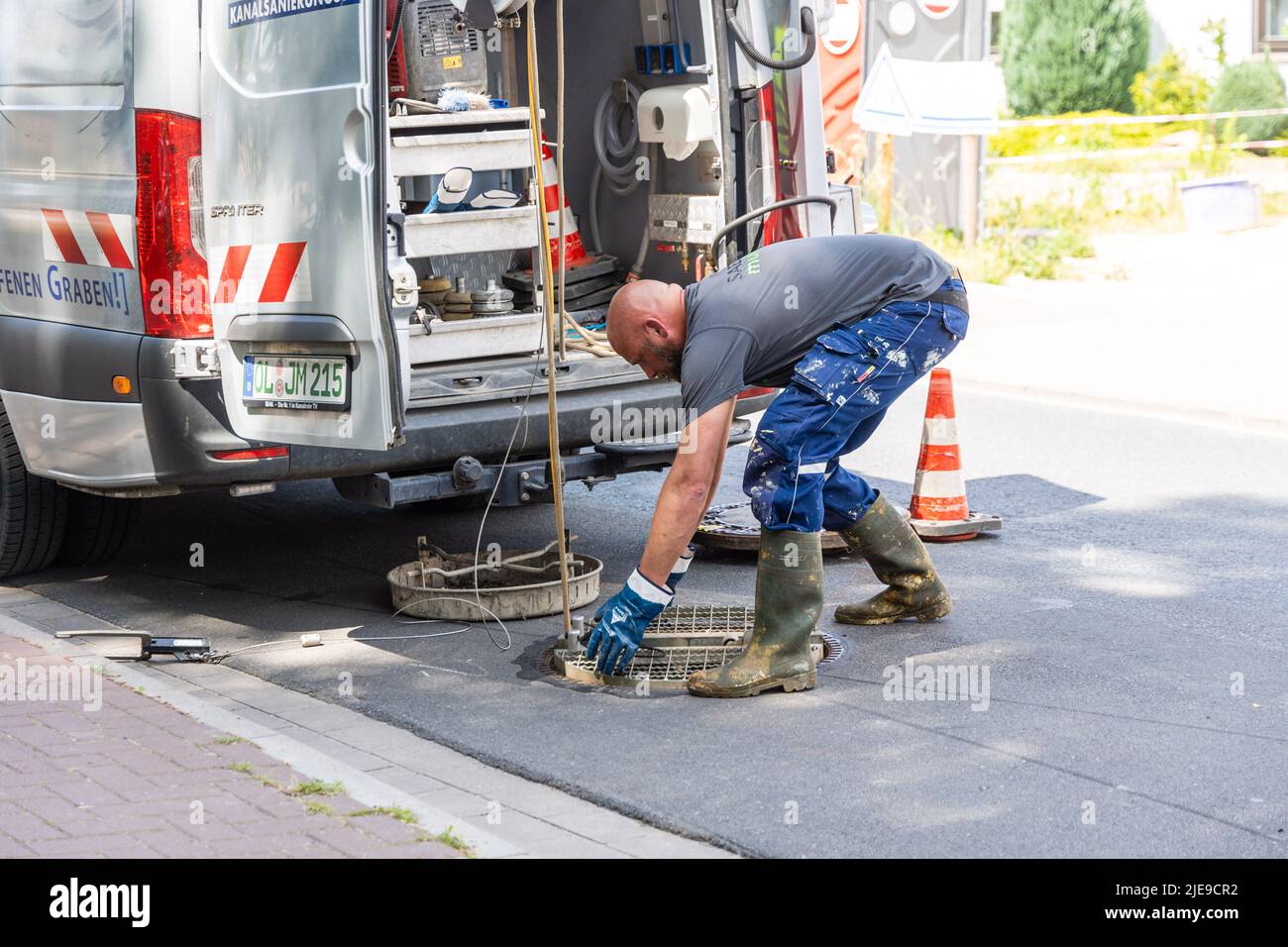 Oldenburg, Germany. 26th June, 2022. Marc Meyerholz opens a manhole ...