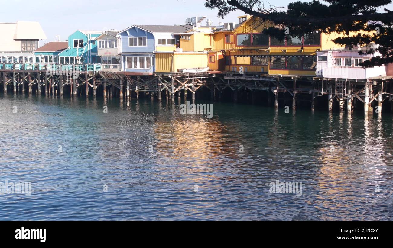 Colorful wooden houses on piles, pillars or pylons, ocean sea water ...