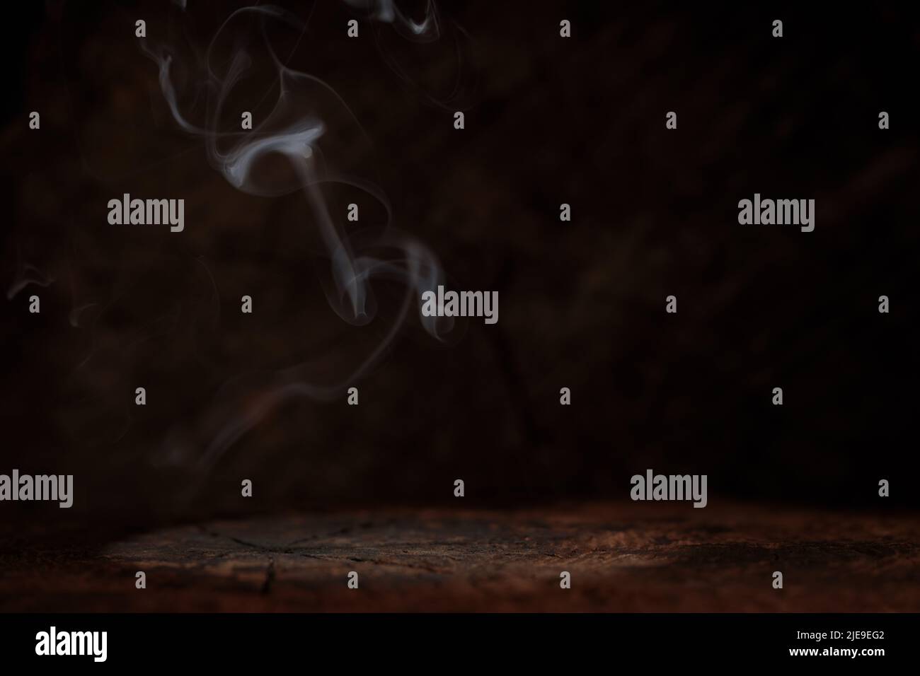 Empty wooden table with smoke float up on dark background Stock Photo ...