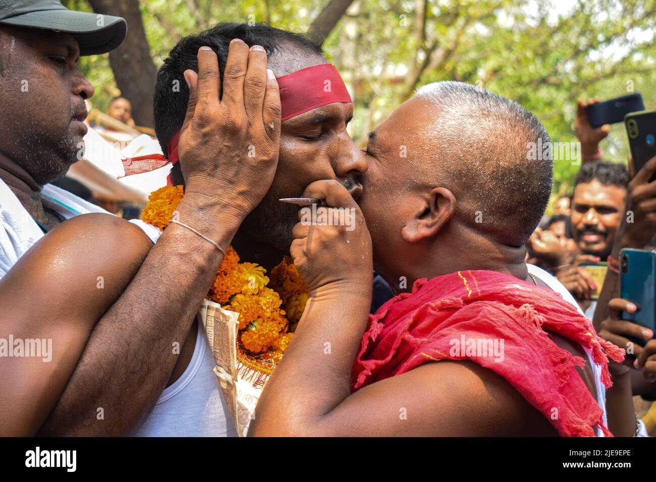 New Delhi, India. 26th June, 2022. A temple priest performs a ritual of ...