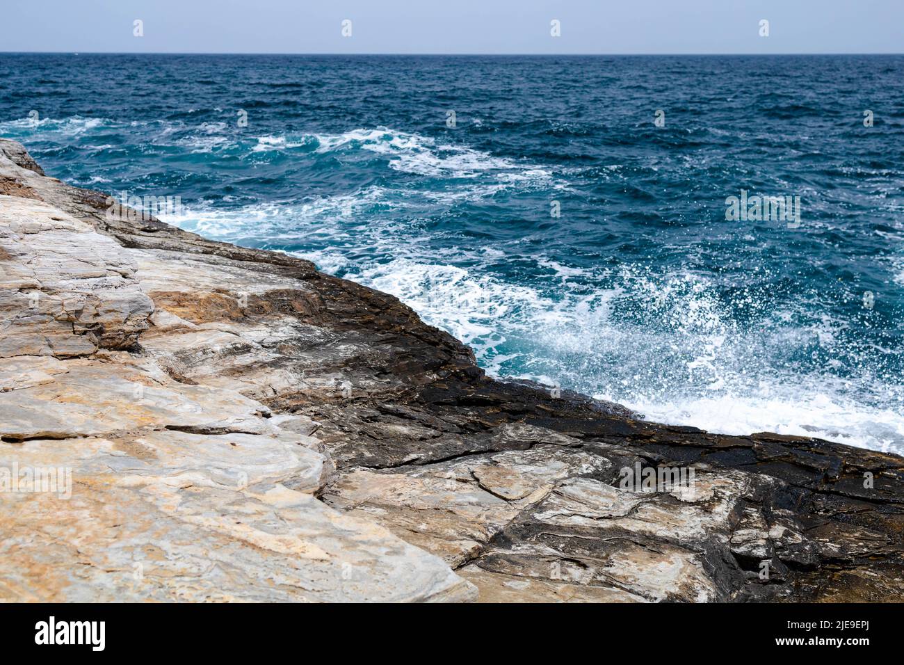 Sea waves hit the rocks on the beach in Greece Stock Photo - Alamy