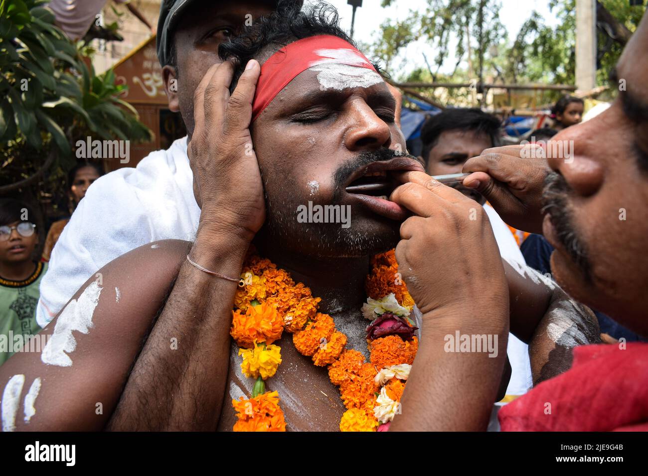 New Delhi, New Delhi, India. 26th June, 2022. A temple priest performs ...