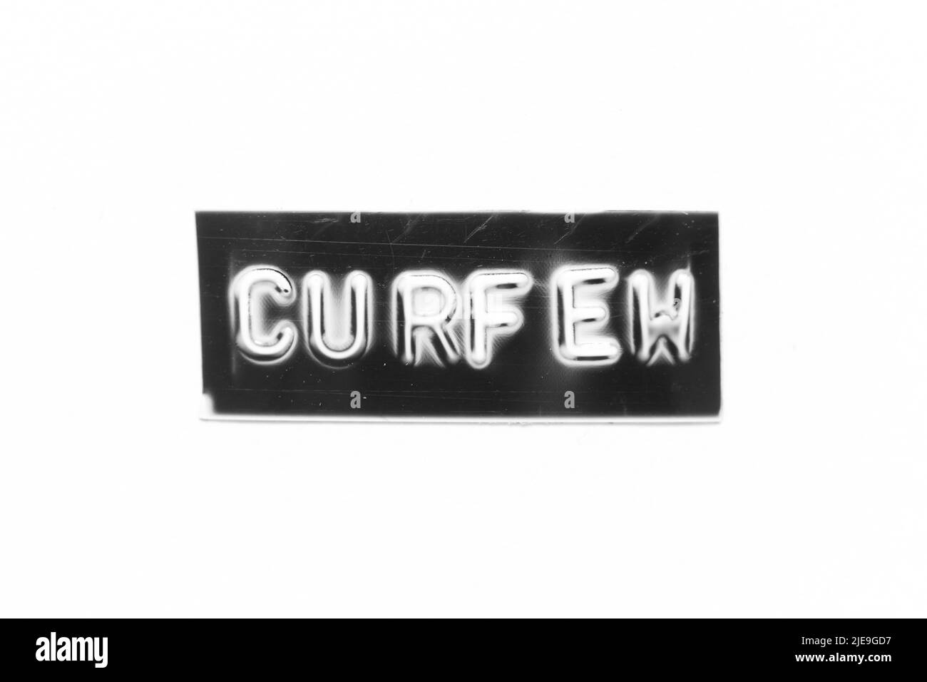 Black color banner that have embossed letter with word curfew on white ...