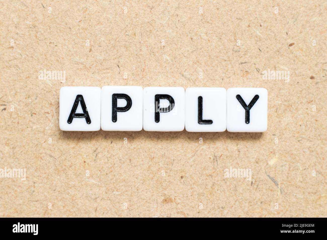 White tile alphabet letter with word apply on wood background Stock ...