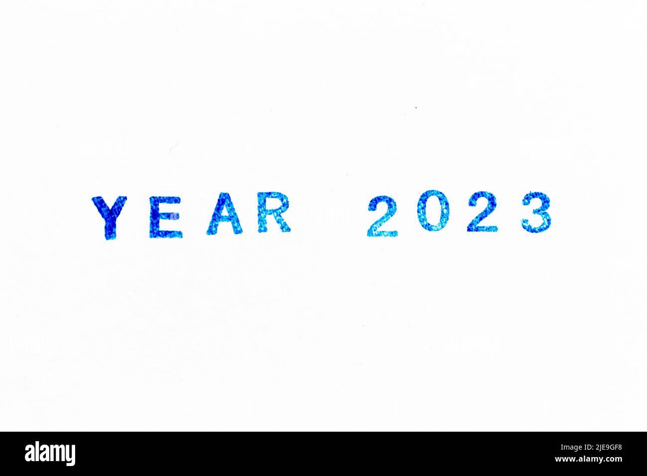 Blue color ink of rubber stamp in word year 2023 on white paper ...