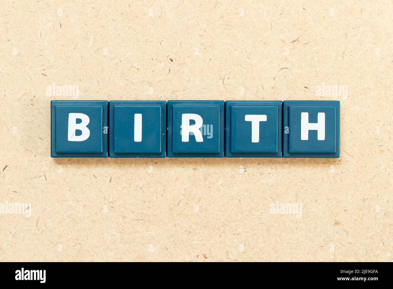 Tile alphabet letter in word birthon wood background Stock Photo - Alamy