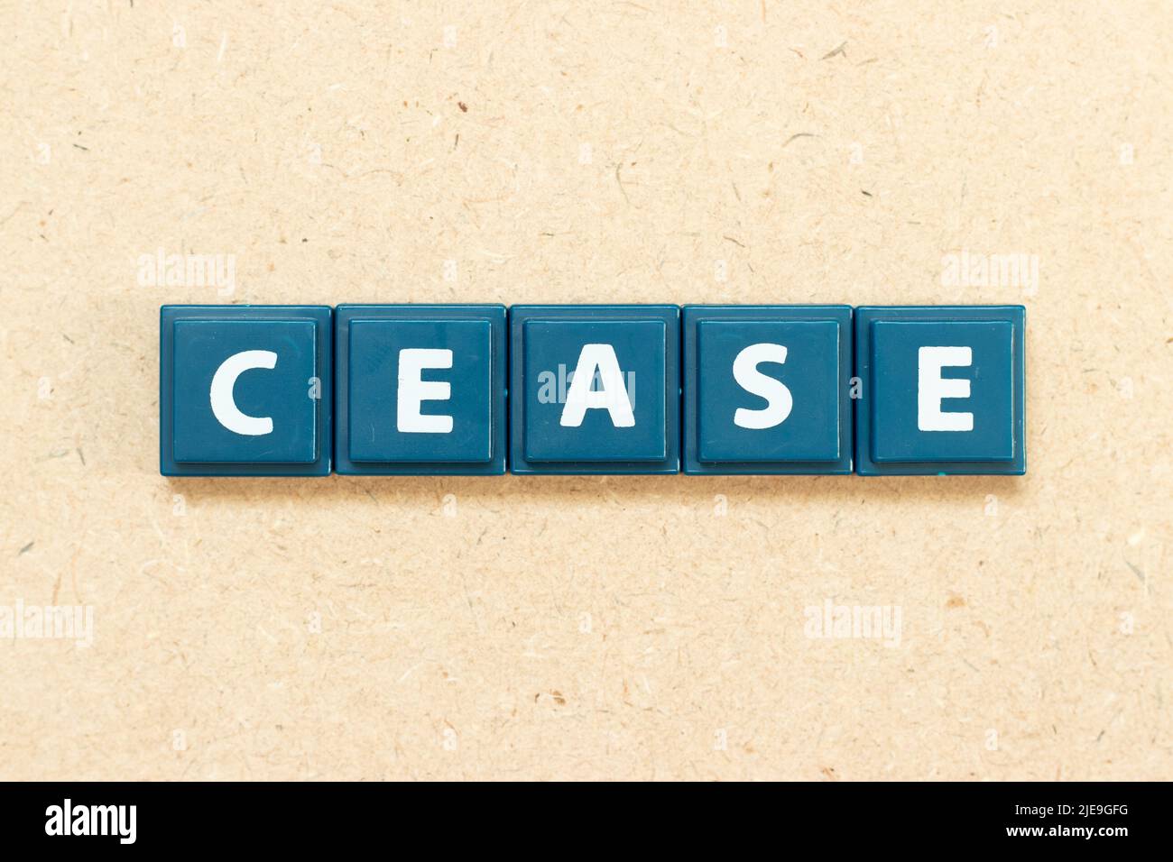 Tile alphabet letter in word cease on wood background Stock Photo - Alamy