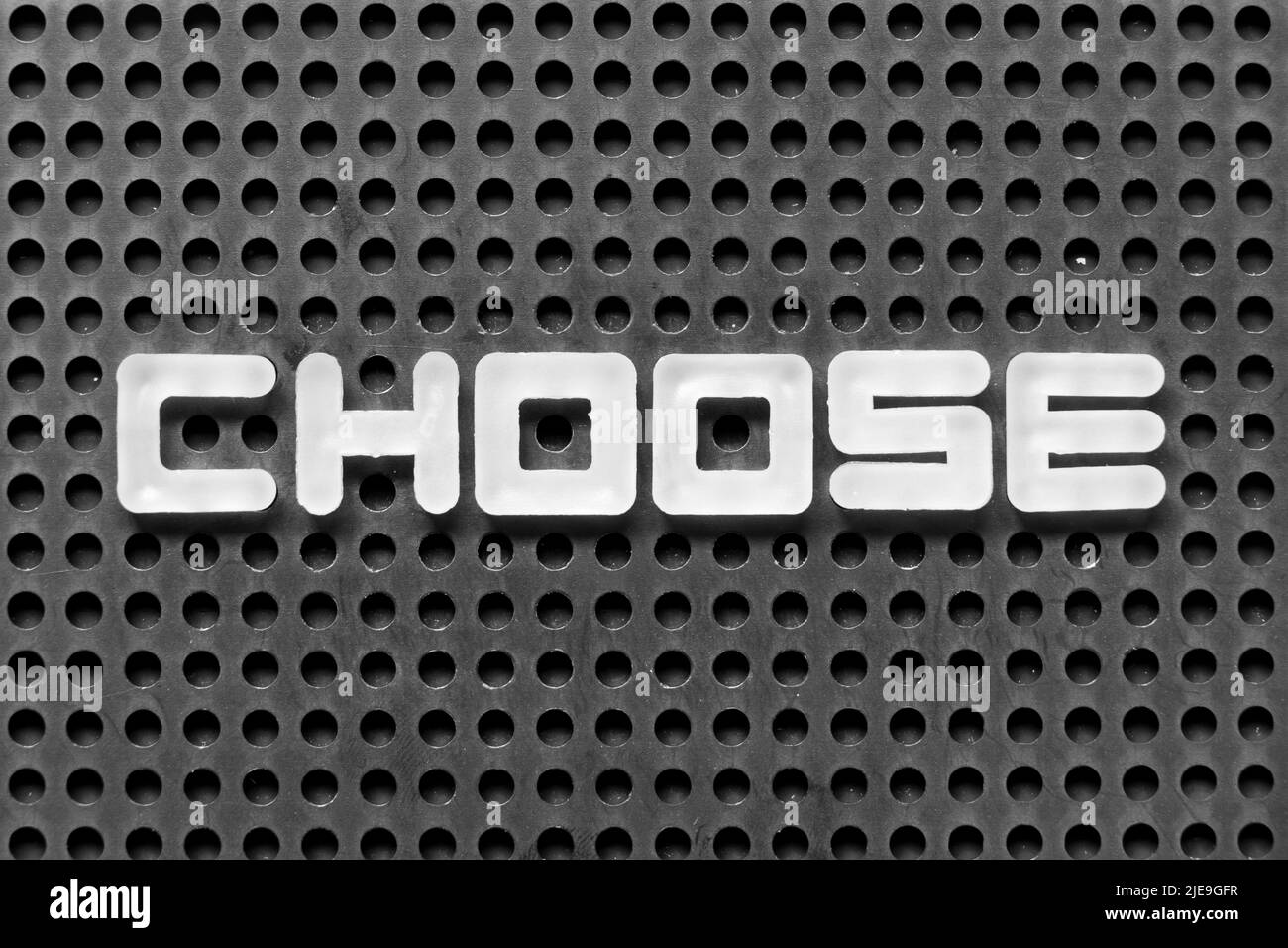 White alphabet letter in word choose on black pegboard background Stock ...
